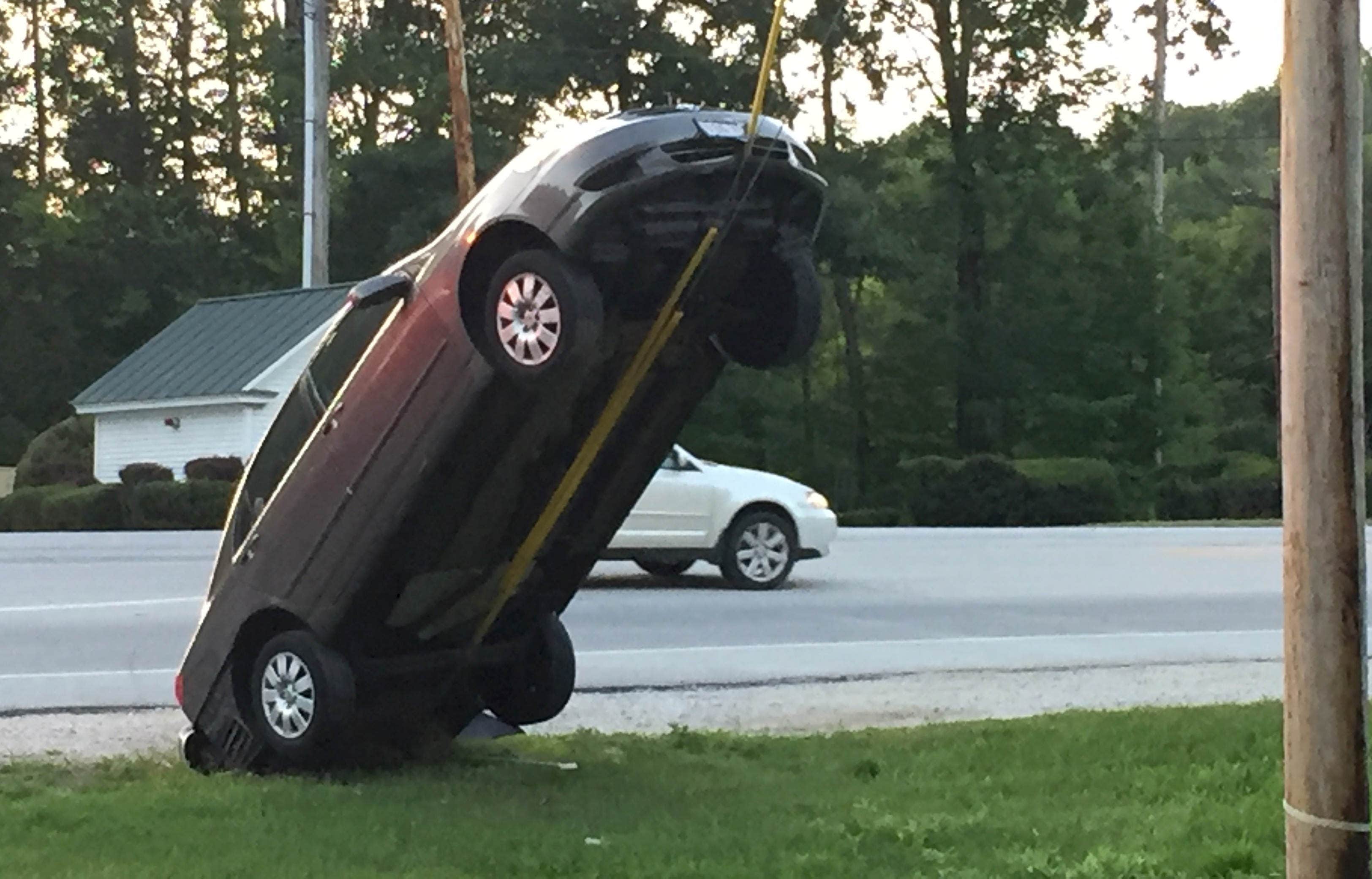 Car nearly ends up vertical after driver swerves ferociously in ...