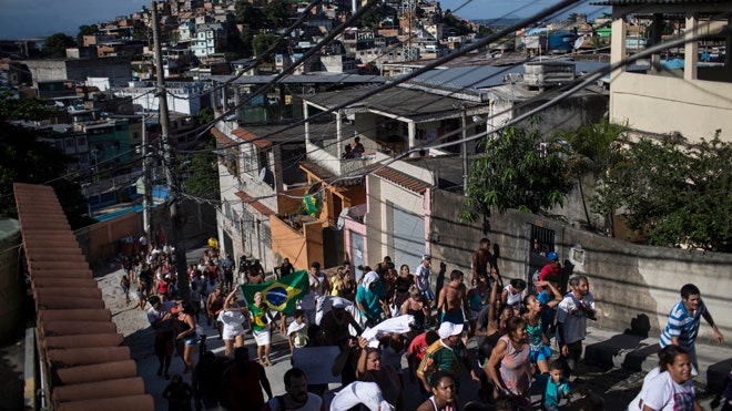 Protests erupt in one of Rio's largest favelas after police allegedly ...