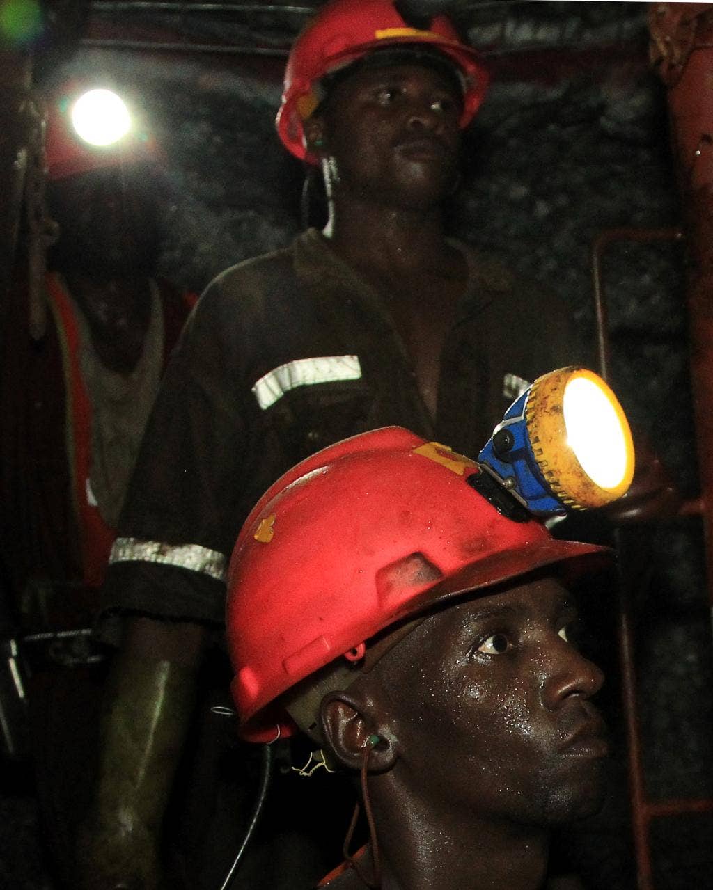 The world below: South African gold miners wrestle with the rock face ...