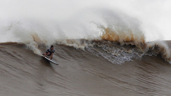 Miles-long wave making its way to the Amazon, surfers happily line up ...