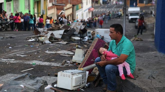 WATCH: Venezuelans eating out of trash, raiding trucks due to food ...