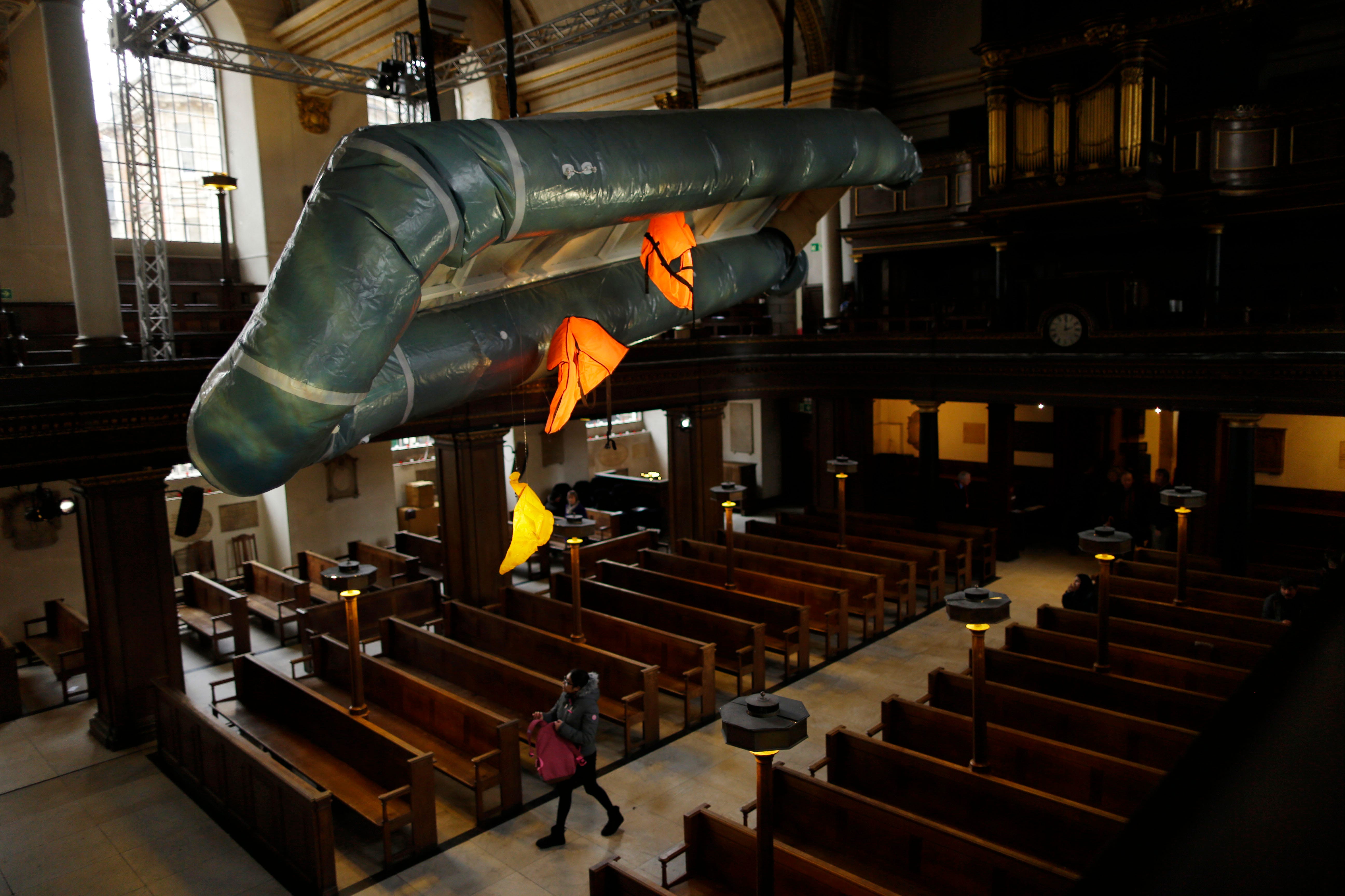 London church hangs deflated dinghy in powerful reminder of refugee ...