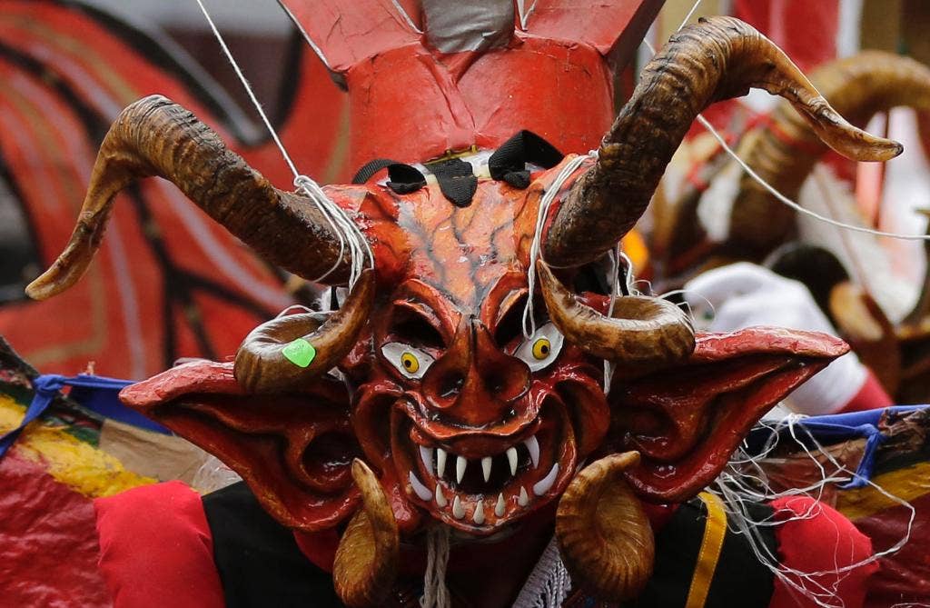 AP PHOTOS: Masked devils dance in Ecuadorean mountain town
