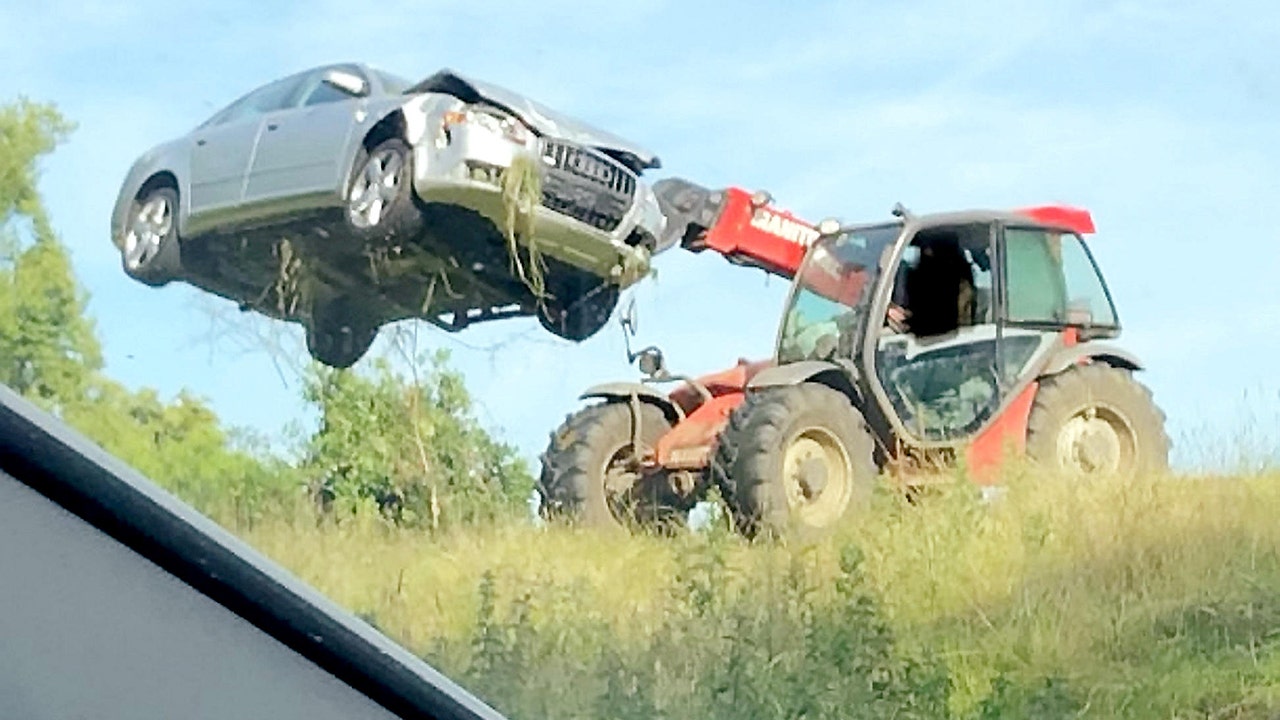 Farmer uses machine to toss crashed car from field as police watch ...