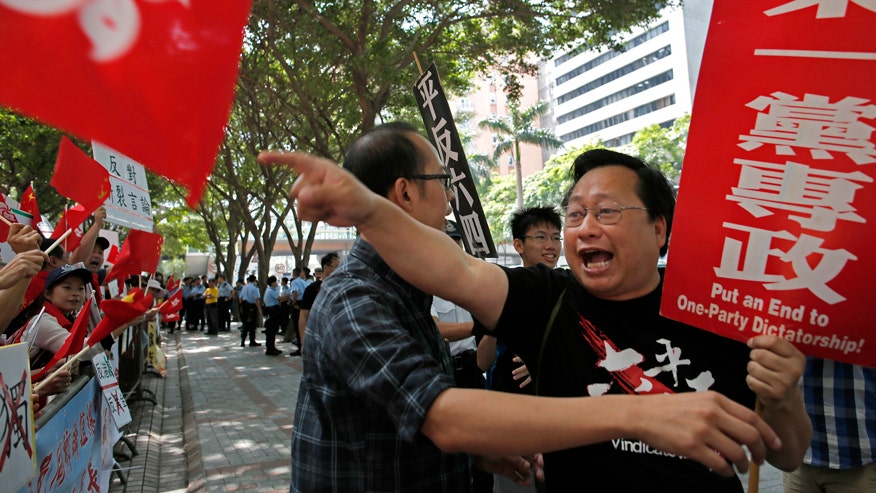 Protesters in Hong Kong rally against Chinese official as authorities ...