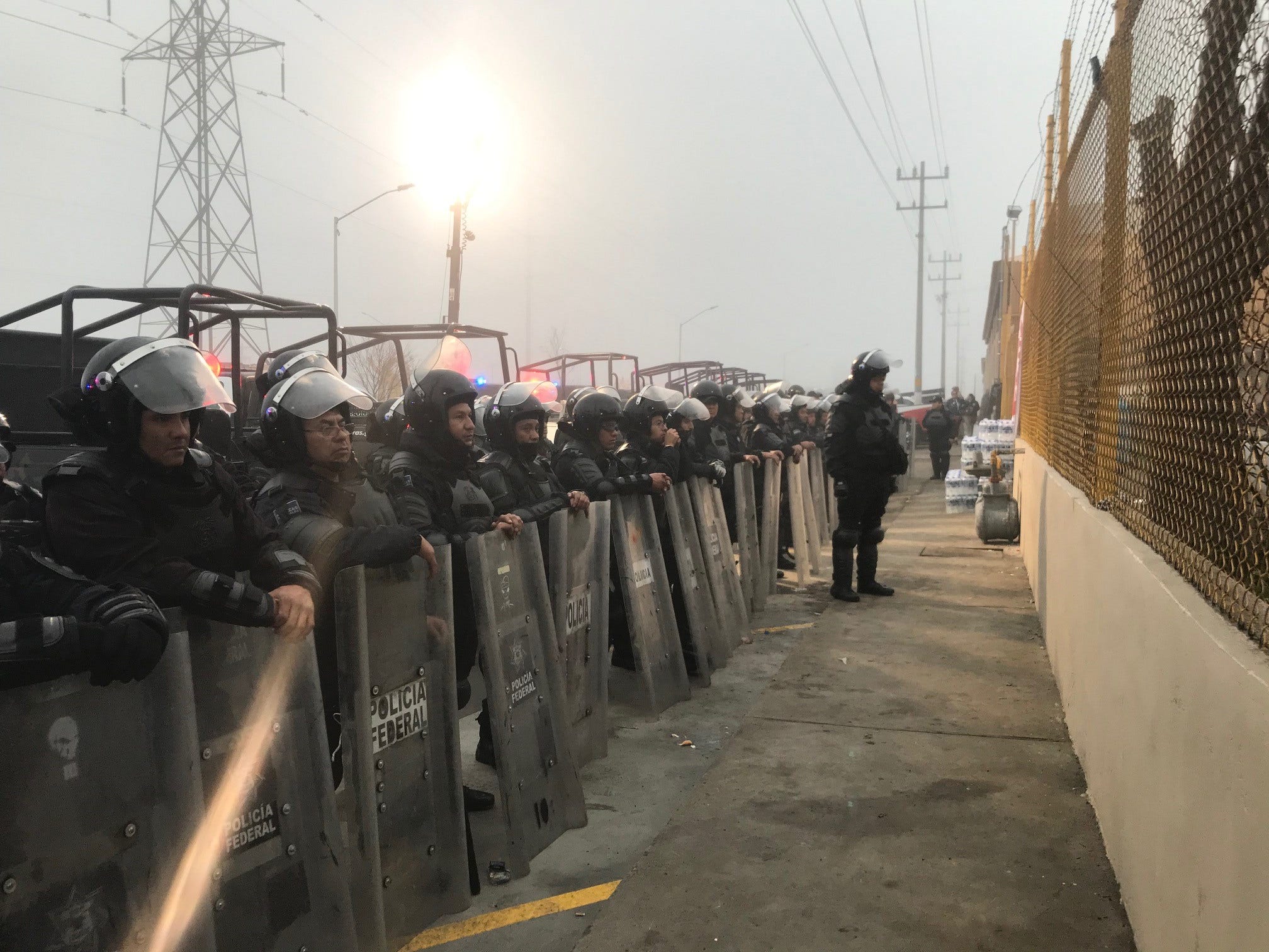 Police in riot gear line up at border to greet migrant caravan as US ...